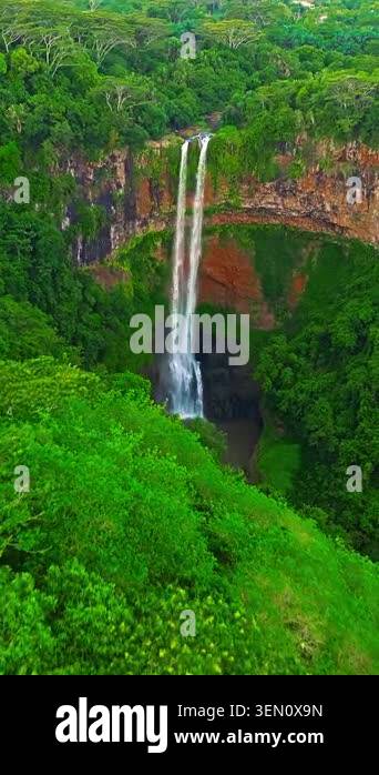 Aerial view of Chamarel Waterfall, plunging from verdant cliff into ...