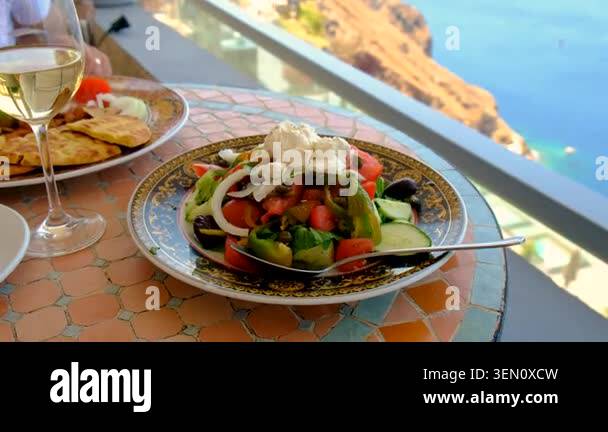 Greek salad and wine in Greece in a restaurant. Selective focus. Food ...