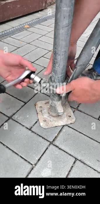 Close-up of construction workers hands using a ratcheting box-end ...