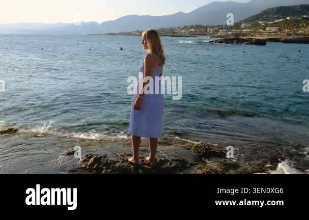 Woman on the beach with the sea in the background. Selective focus ...