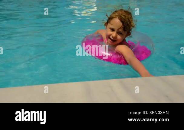 Child swimming in a pool with a ring. Selective focus. kid Stock Video ...