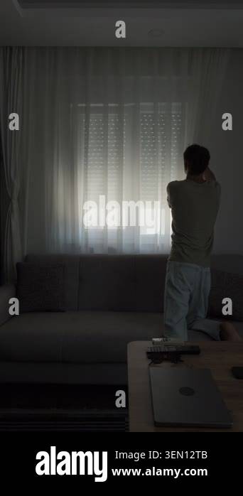 Morning routine opening blinds with natural sunlight in cozy apartment ...