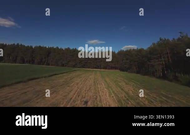 Dynamic FPV drone footage flying low over cultivated agricultural ...