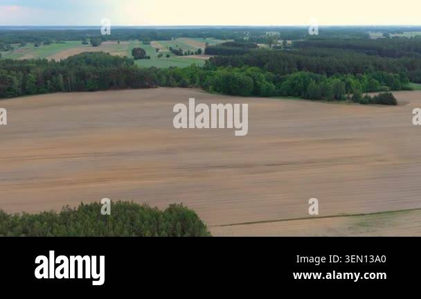 Drone footage of expansive countryside landscape featuring cultivated ...