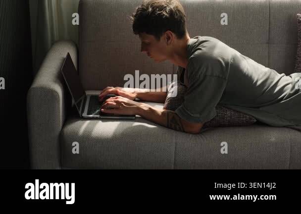 Remote worker using couch as improvised workspace adapting home ...