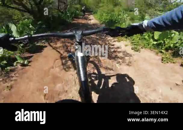 Man ride mountain bike in the mountain steep trail tough the forest ...
