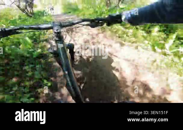 Man ride mountain bike in the mountain steep trail tough the forest ...
