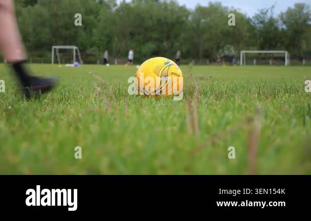 Leg of young boy shooting a penalty kicks on stadium at summer day ...
