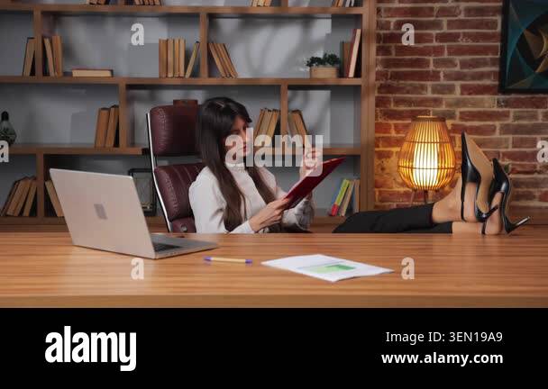Caucasian business woman sits at a desk, raises hand while sharing ...