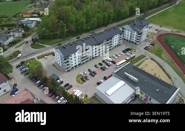 Aerial Footage of Modern Residential Building with Parking Area and ...