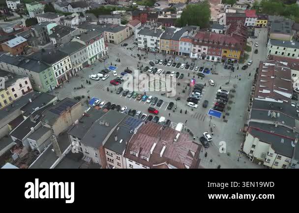 Aerial Footage of Town Square with Historic Buildings and Parking Area ...