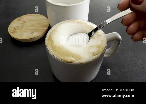 Sequence of coffee preparation with sugar added, stirring the frothy ...