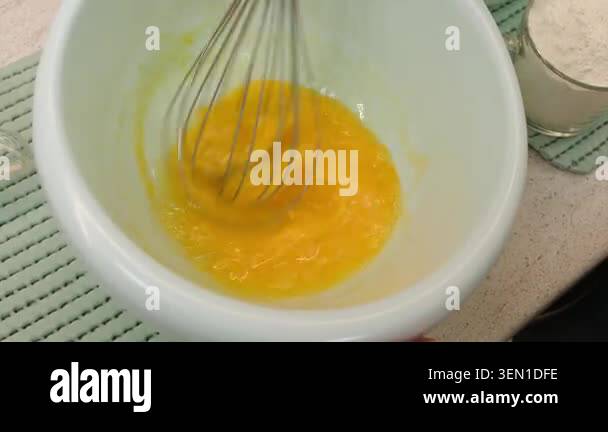 Beaten eggs in a bowl for pancake batter, with a whisk Stock Video ...