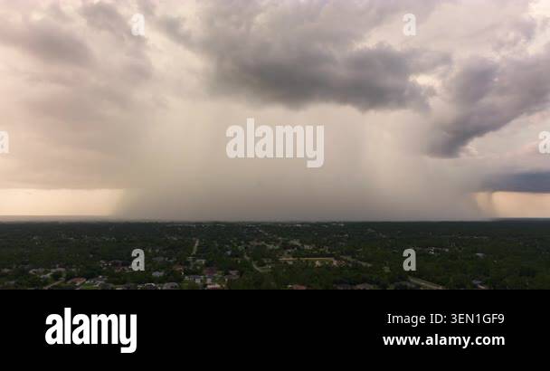 Rainstorm shower over Florida rural town in humid summer season. Rain ...