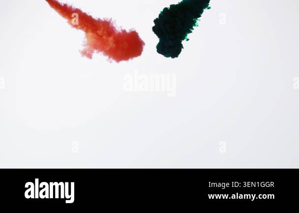 Colorful ink swirls dance against a pure white backdrop. Red and blue ...