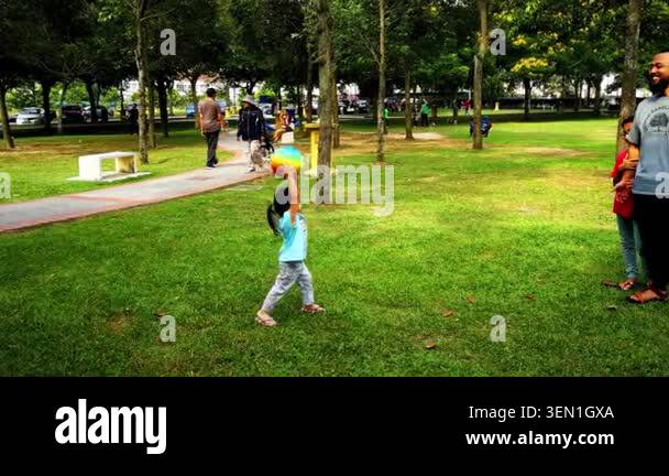 Happy asian family playing ball in the park Stock Video Footage - Alamy