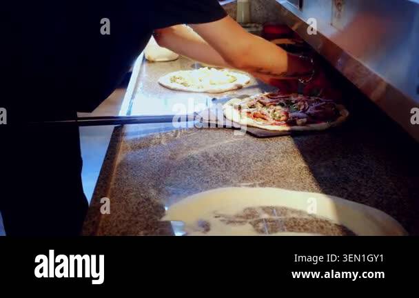 Authentic pizza making process in traditional Italian pizzeria, while ...