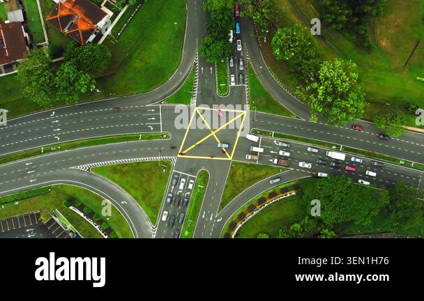 Aerial view of a busy intersection with cars navigating traffic and ...