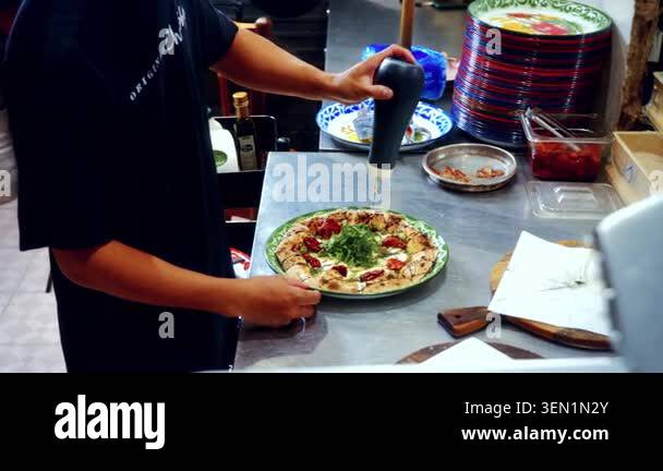 Authentic pizza making process in traditional Italian pizzeria, while ...