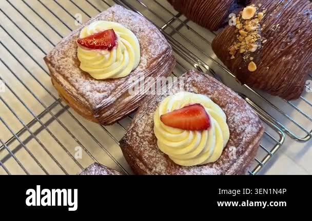 Two delicate puff pastry treats filled with smooth cream and topped ...