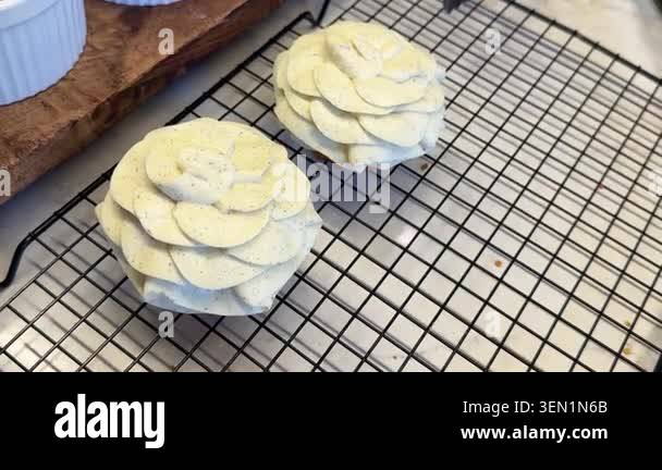 Two delicate desserts crafted to resemble blooming roses feature smooth ...