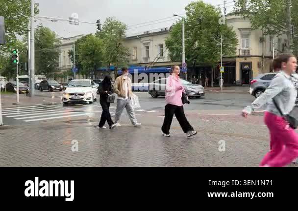 Everyday life in central Chisinau during rainy weather as cars travel ...