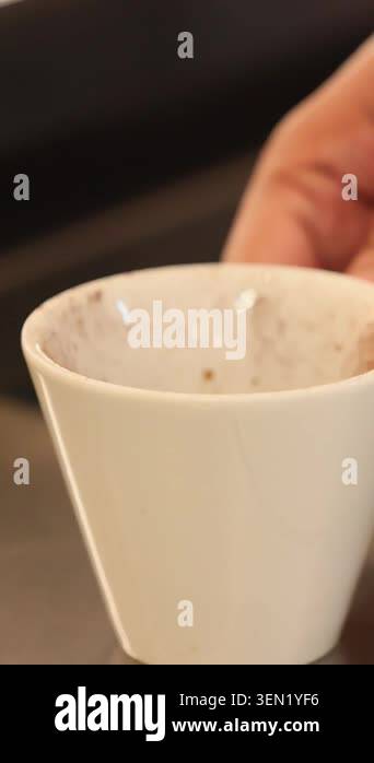 Barista pouring cappuccino foam into cup in close coffee preparation ...