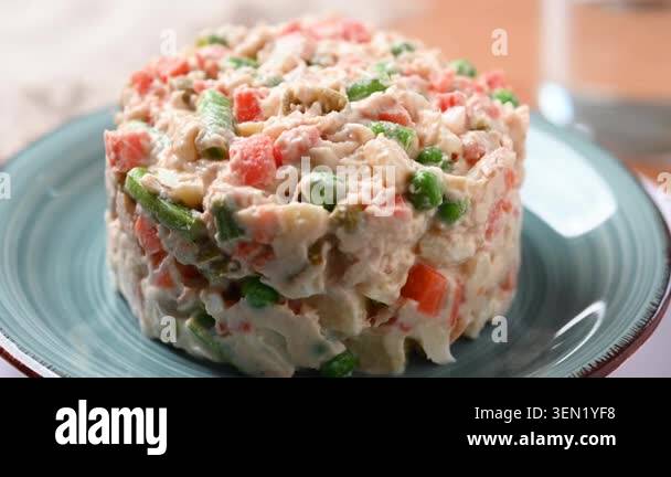 Rotating Russian salad on wooden table Stock Video Footage - Alamy