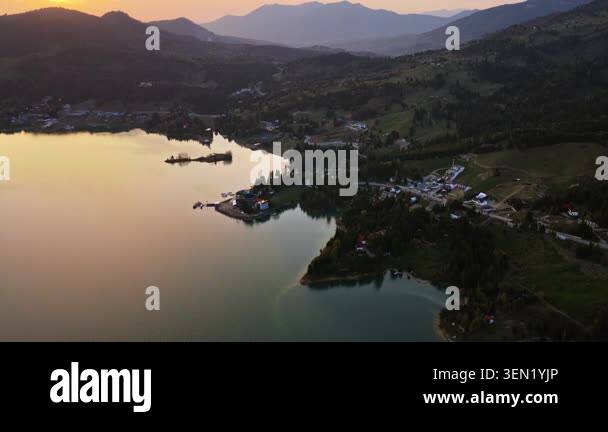 Aerial drone view of the Colibita lake with peninsulas and small built ...