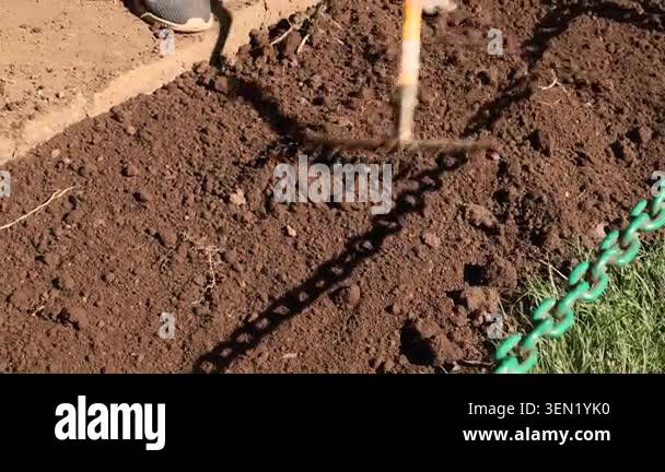Close up of rake working soil texture during field preparation for ...