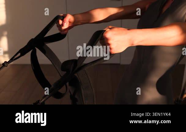 Woman training back and legs on Pilates reformer machine in modern ...