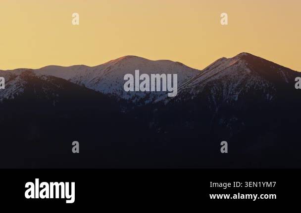 Aerial drone view of snow covered mountain peaks under soft light, part ...
