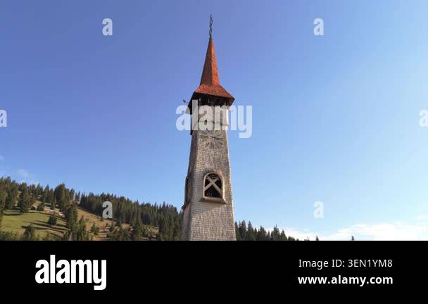 Aerial drone view of a traditional wooden church tower with a tall ...