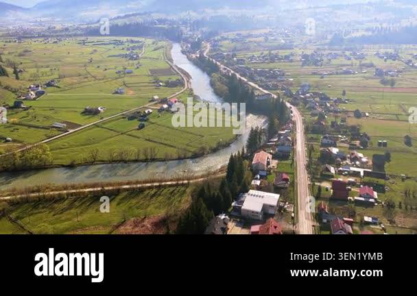 Aerial drone view of a mountain village near Colibita Lake, Romania ...