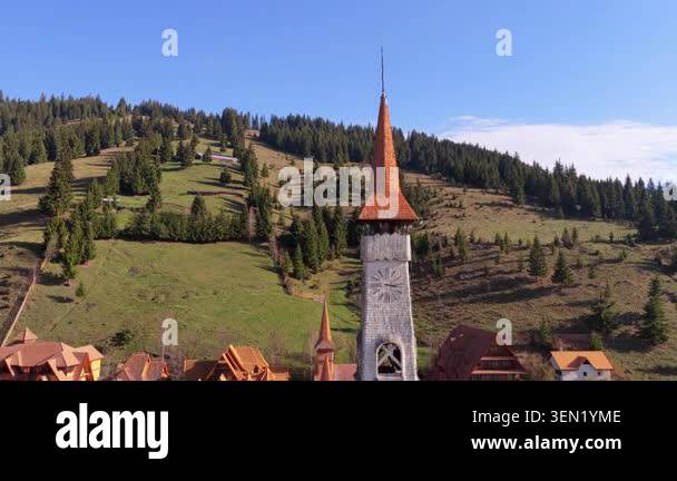 Aerial drone view of a traditional wooden church tower with a tall ...