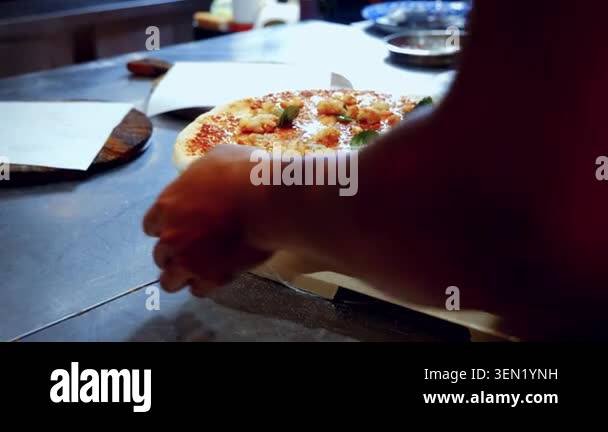 Authentic pizza making process in traditional Italian pizzeria, while ...