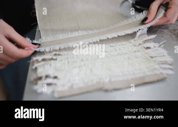 Close up of fabric layers being aligned and inspected, showing raw ...