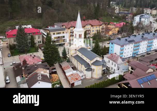 Aerial drone view of a church surrounded by residential buildings in ...