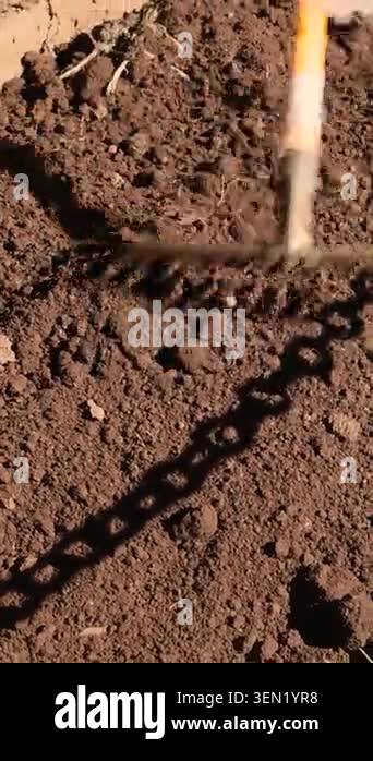 Close up of rake working soil texture during field preparation for ...