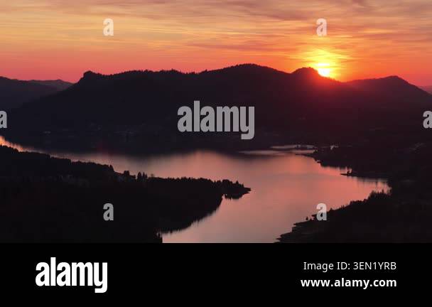 Aerial drone view of Colibita lake partially visible between darkened ...