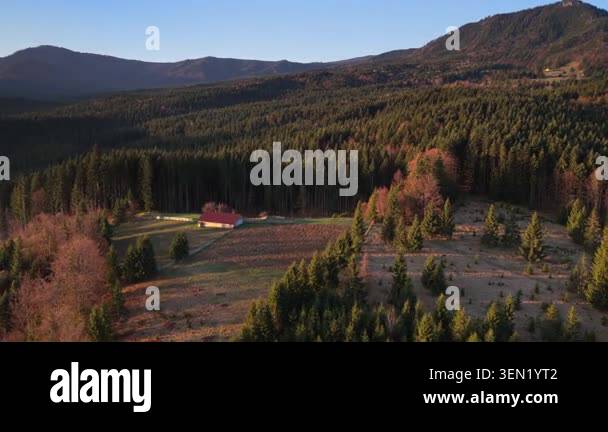 Aerial drone view over a cultivated hillside with fields and a few ...