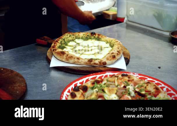 Authentic pizza making process in traditional Italian pizzeria, while ...