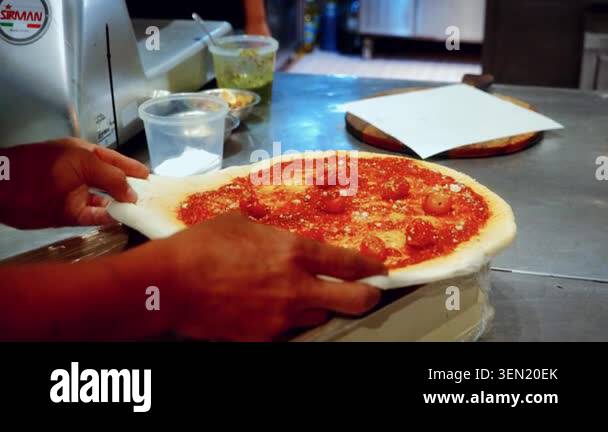 Authentic pizza making process in traditional Italian pizzeria, while ...