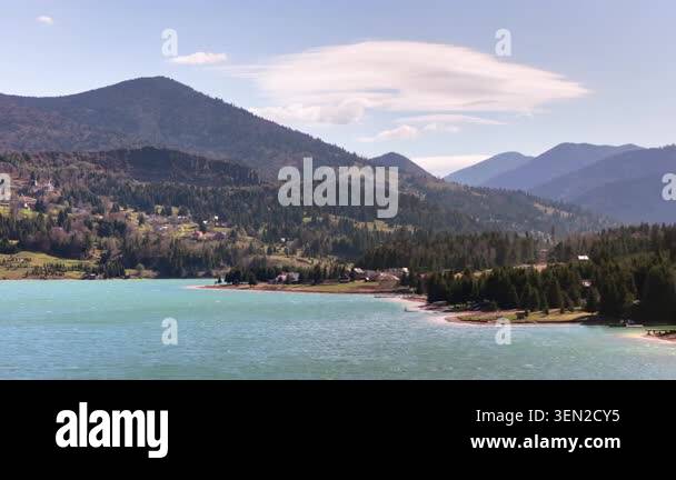 Aerial drone view showing Colibita lake and surrounding hills with ...