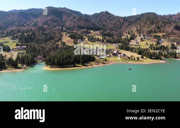 Aerial drone view showing Colibita lake and surrounding hills with ...
