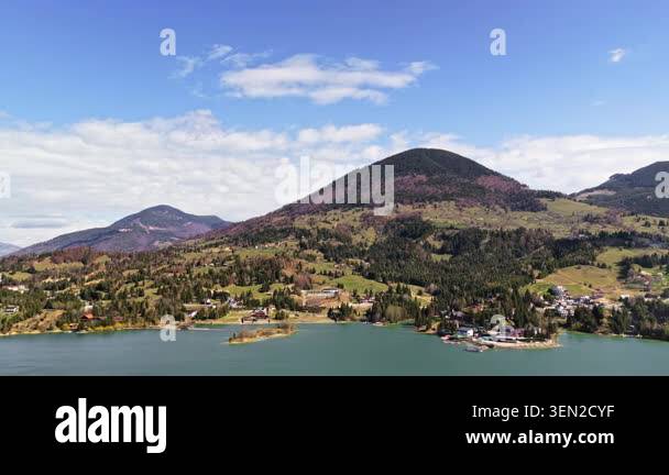 Aerial drone view showing Colibita lake and surrounding hills with ...