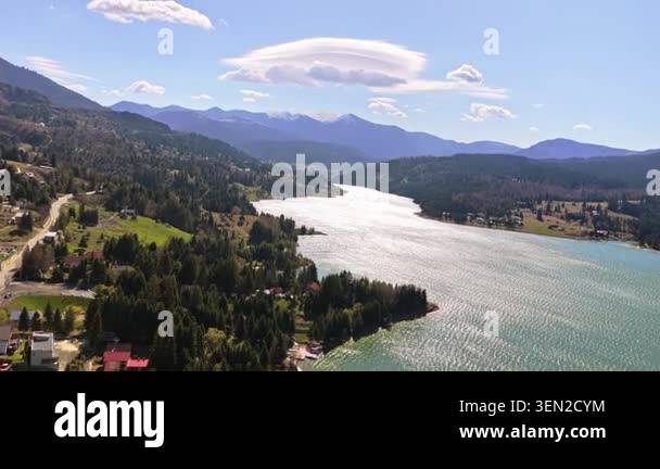 Aerial drone view of Colibita Lake with turquoise waters surrounded by ...