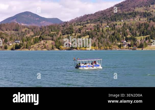 Aerial drone view of a small passenger boat moving across the Colibita ...