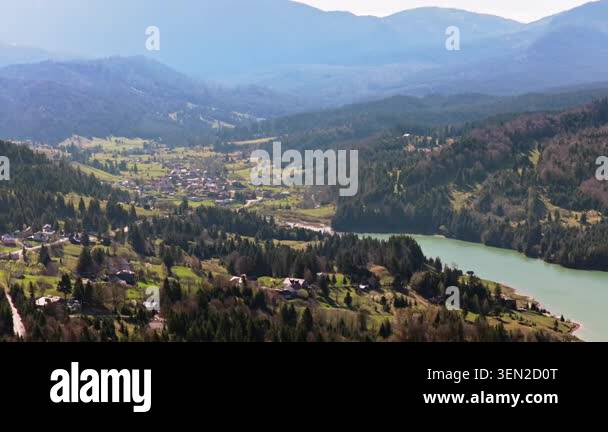 Aerial drone view of a rural mountain village near Colibita Lake ...