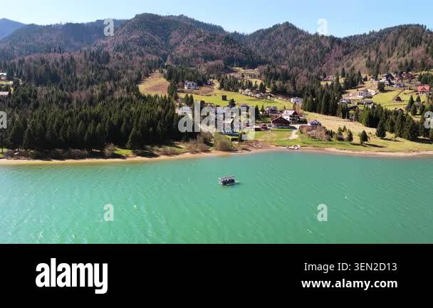 Aerial drone view of a small lakeside settlement along Colibita Lake ...